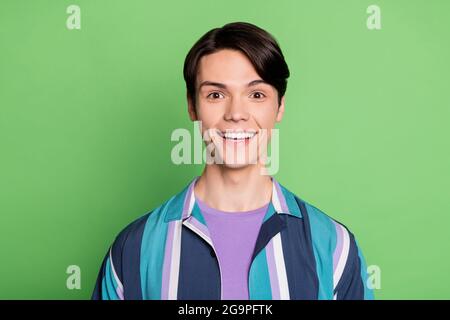 Photo of impressed young brunet guy wear yellow shirt isolated on blue ...