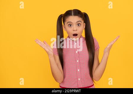 OMG. Surprised child yellow background. Wide-eyed girl got surprised ...