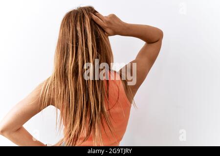 Hispanic woman with bang hairstyle standing over isolated background ...