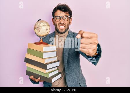 Hispanic man with beard geography teacher smiling happy pointing with ...
