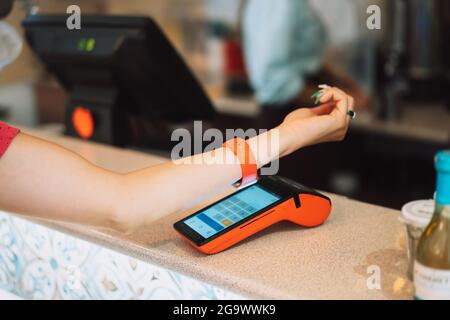 Contactless payment from watch via pos terminal Stock Photo - Alamy