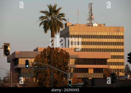 Sunset ground level view of the skyline of Bakersfield, California, USA ...