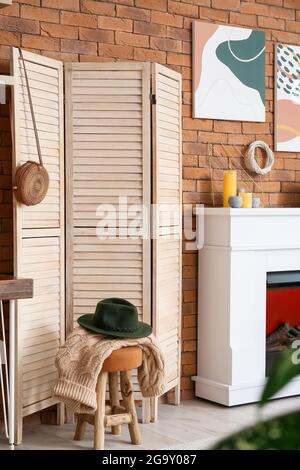 Stylish room with folding screen and fireplace. Interior design Stock ...
