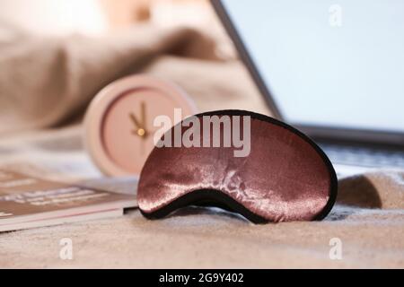 Stylish sleeping mask and magazine on table in bedroom Stock Photo - Alamy