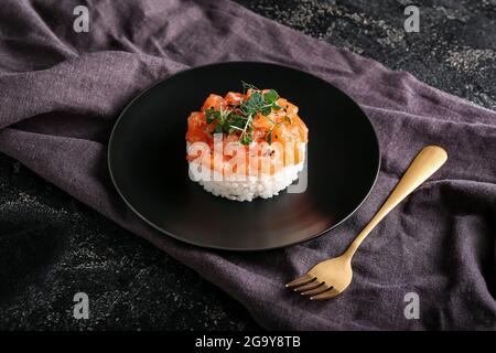 Delicious salmon tartar on dark wooden background Stock Photo - Alamy