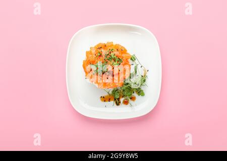 Delicious salmon tartar on color background Stock Photo - Alamy