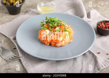 Delicious salmon tartar on grunge background, closeup Stock Photo - Alamy
