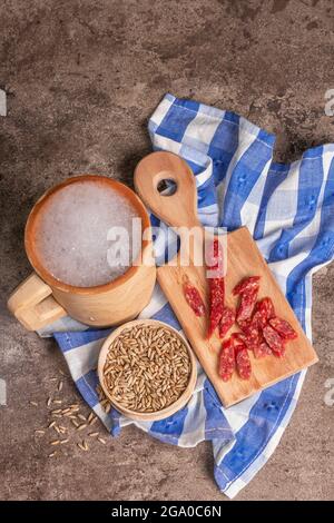 Oktoberfest concept. Beer and grain, sausages, wooden mugs. A trendy ...