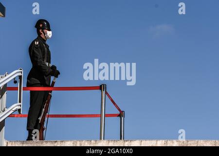 A Turkish soldier wearing a protective face mask stands during a change ...