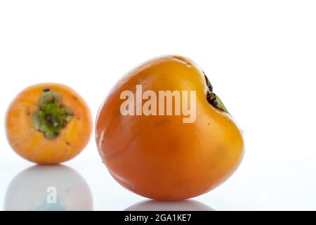 Two ripe organic persimmons, close-up, isolated on white Stock Photo ...