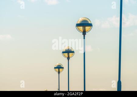 Lamp posts in a row at sunlight Stock Photo - Alamy