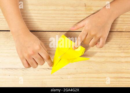 Human hand folding a colored paper isolated over white background Stock ...