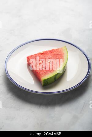 Large red raw watermelon pieces on a plate. It sweet, juicy flesh ...