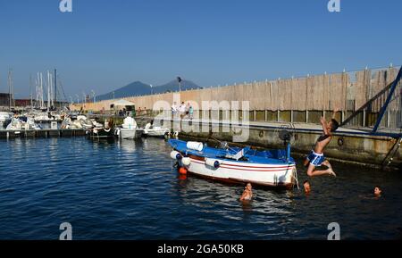 Italian children jumping into the water at the Porticciolo Molosiglio ...