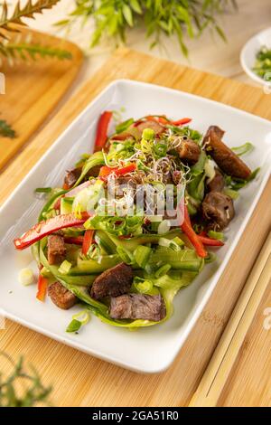 Asian style salad with beef cubes decorated with sprouts Stock Photo ...