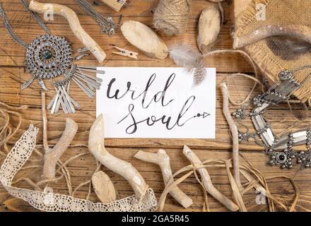 Card with the handwritten text WILD SOUL with bohemian decorations ...