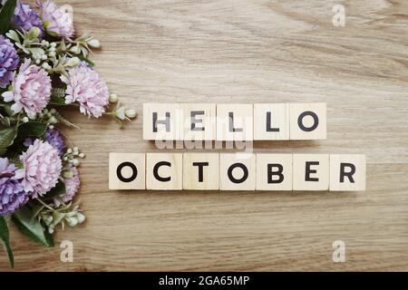 Hello October alphabet letters with pink flower decoration on wooden ...