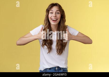 Cheerful suportive energized cute european cute curly-haired girl show ...