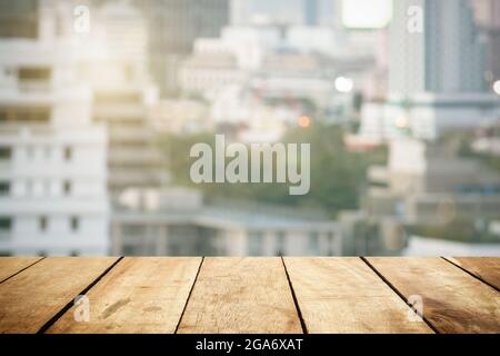 Panoramic empty grunge wood counter table top on blur glass window ...