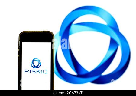In this photo illustration a RiskIQ logo seen displayed on a smartphone with a Microsoft ...