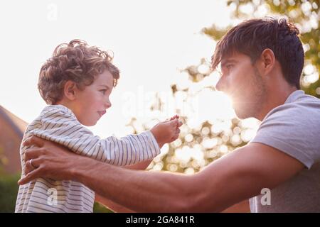 Loving Father With Son Having Fun In Garden At Home Together Stock ...