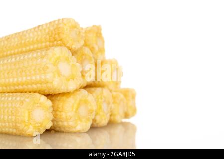 A few bright yellow ripe sweet organic mini corn, close-up, on a white ...
