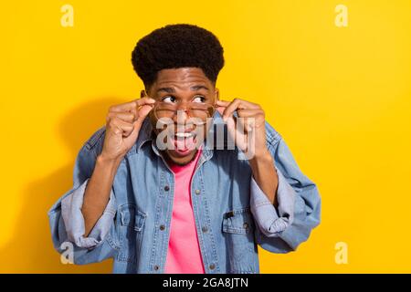 Photo of young dark skin curious woman look empty space minded bite ...