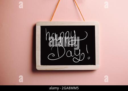 Wooden framed small blackboard with a "Enjoy the Sun" writing hanging ...