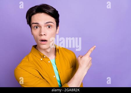 Photo of impressed young brunet guy wear violet hoodie isolated on ...