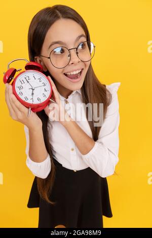 surprised nerd child listen the alarm clock ringing. school kid in ...