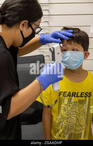 Boy getting eye exam at optometrist's office, USA Stock Photo - Alamy