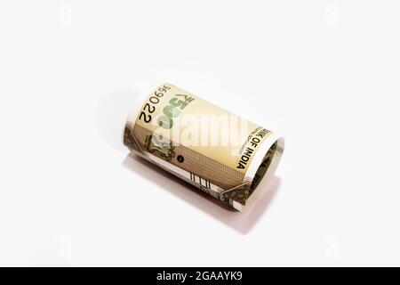Indian five thousand rupees rolled up banknote isolated on white ...