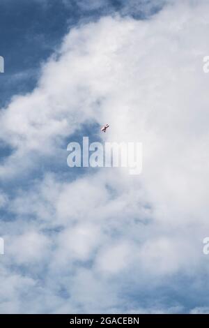 A Pitts Special aerobatic biplane performing a series of rolls and ...