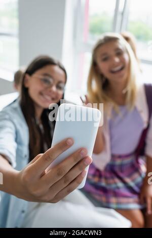 Teen boy taking selfie with smartphone and shoulder bag Stock Photo - Alamy