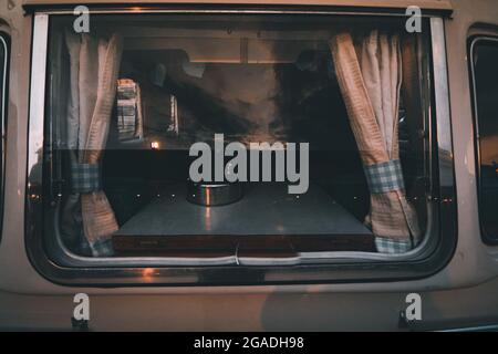 View inside a vintage cute bus through a small window with curtains ...
