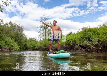 Adventurous Hispanic Adult Athletic Man paddle boarding Stock Photo - Alamy