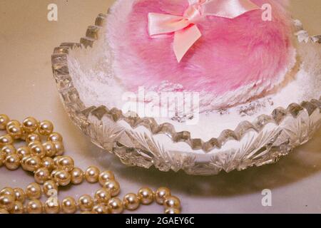 Close up of woman's vanity including talcum powder with puff in a cut ...
