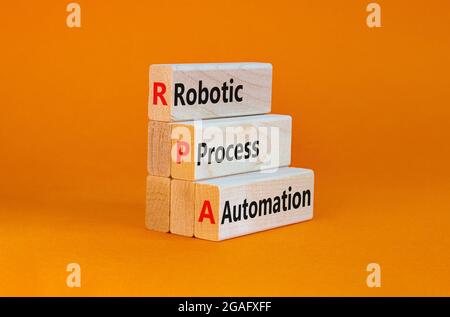 RPA, robotic process automation symbol. Wooden blocks with words RPA ...
