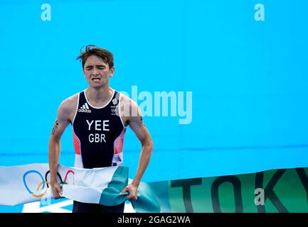 Great Britain's Alex Yee crosses the line to win gold following the Men ...