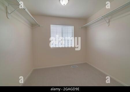 Interior walk-in closet, simple classic style in white tones. Panoramic ...