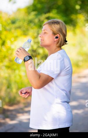 Senior woman wearing sportswear and headphones smiling pointing to head ...