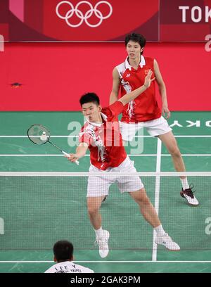 Lee Yang (back) and Wang Chi-Lin (front) of Chinese Taipei are seen in ...