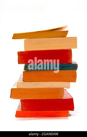 Close up of stacked up books on a white background with space for text ...