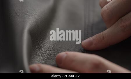 Closeup man touching fine leather, wide photo Stock Photo - Alamy