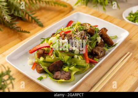 Asian style salad with beef cubes decorated with sprouts Stock Photo ...