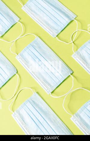 A vertical view of a disposable protective masks lying in the beige ...