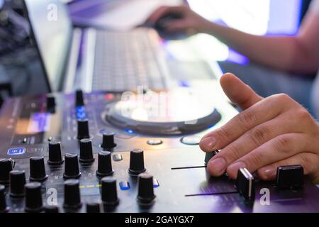 DJ controls a remote at a club party Stock Photo - Alamy
