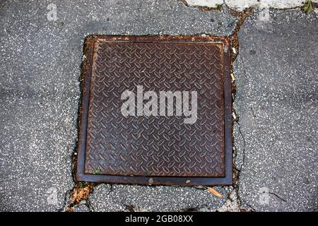 Square metal hatch on asphalt road Stock Photo - Alamy