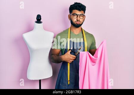 Arab man with beard dressmaker designer wearing atelier apron smiling ...
