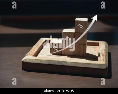 Shining rise up arrow on wooden blocks chart steps with percentage ...
